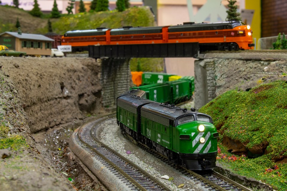 Steam engine rounds the bend around the farm
